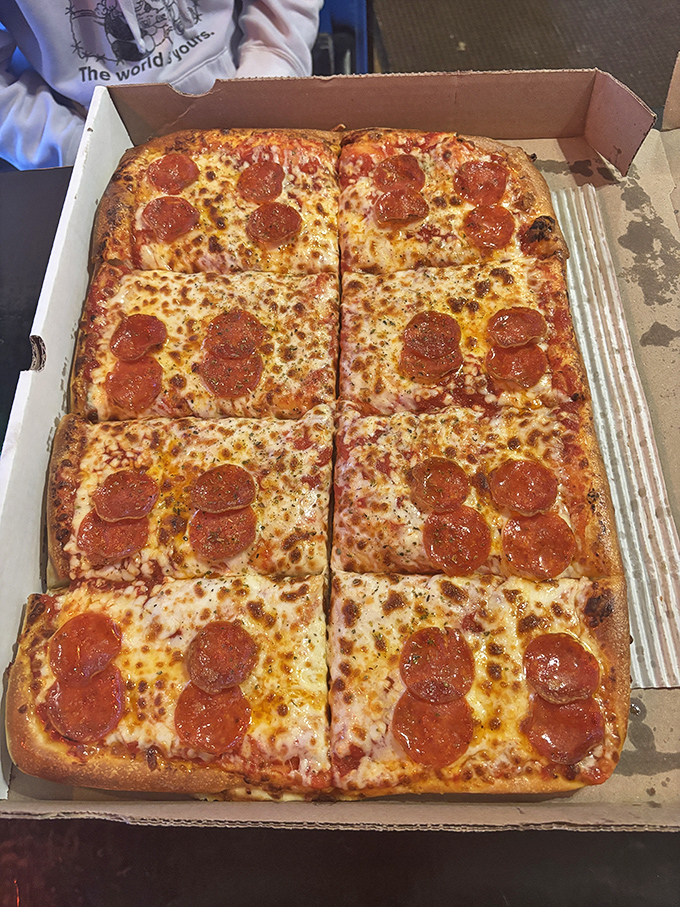 Pizza perfection in square form. Those curled-edge pepperoni cups holding their own savory oils are what dreams are made of.