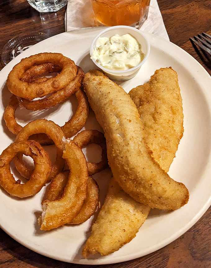 Golden-brown perfection on a plate. These perch fillets with onion rings might be the reason Wisconsin invented the Friday night tradition.