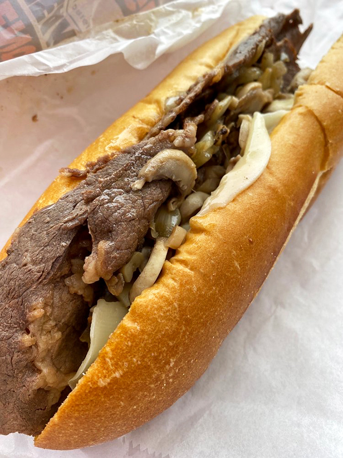 Behold the star of the show: thinly sliced ribeye, perfectly grilled, nestled in a crusty roll. Poetry in sandwich form.