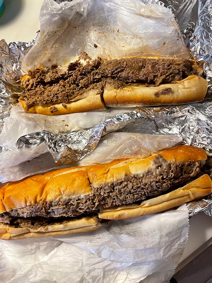 Behold the star attraction: a proper Philly cheesesteak that requires strategic planning to eat. The meat-to-roll ratio here defies physics and conventional sandwich wisdom.