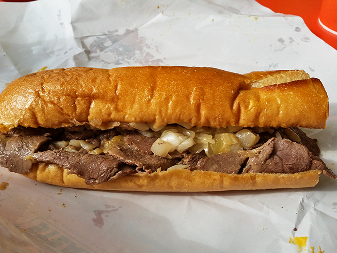 Behold the star of the show! Thinly sliced ribeye nestled in an Amoroso roll with grilled onions – Philadelphia's most famous handheld masterpiece.