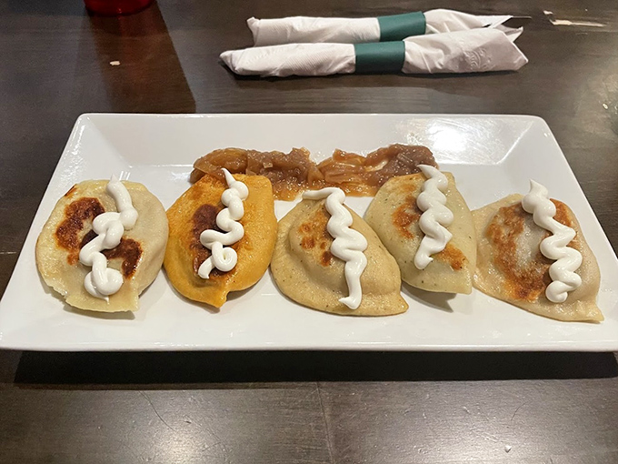 Golden-brown pierogi perfection! These plump dumplings with their zigzag of sour cream are what food dreams are made of&mdash;crispy edges, tender centers, pure joy.