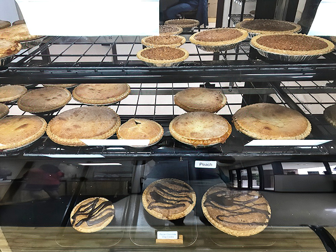 Behold the hierarchy of happiness! Each shelf showcases different varieties, from fruit-filled wonders to decadent cream creations.