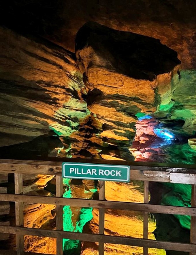 Pillar Rock stands like nature's own architectural masterpiece, illuminated in technicolor cave lighting glory.