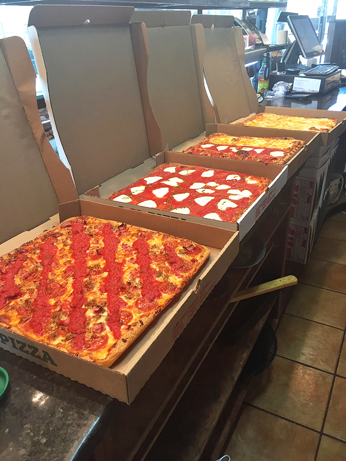 Pizza perfection lined up like soldiers ready for duty. That pepperoni pie is practically winking at you, saying "resistance is futile."