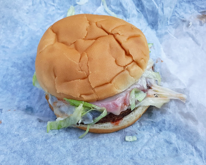 Simplicity at its finest: a perfectly proportioned burger where every bite delivers that ideal ratio of beef, cheese, and fresh toppings.