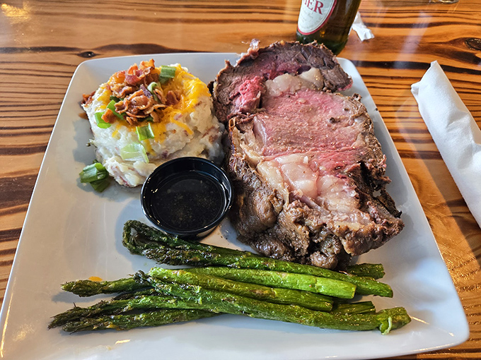 Perfectly pink prime rib alongside loaded mashed potatoes and asparagus – the holy trinity of steakhouse bliss. This plate doesn't just satisfy hunger; it creates memories.