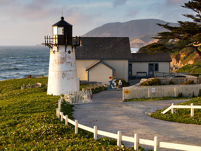 The Point Montara Lighthouse stands like a maritime sentinel, its whitewashed tower a beacon of history against the endless blue canvas of the Pacific.
