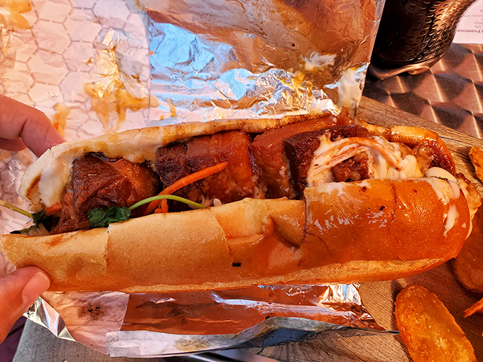 Behold the pork belly masterpiece &ndash; glistening, caramelized chunks nestled in a perfect roll. This isn't a sandwich; it's an edible work of art.