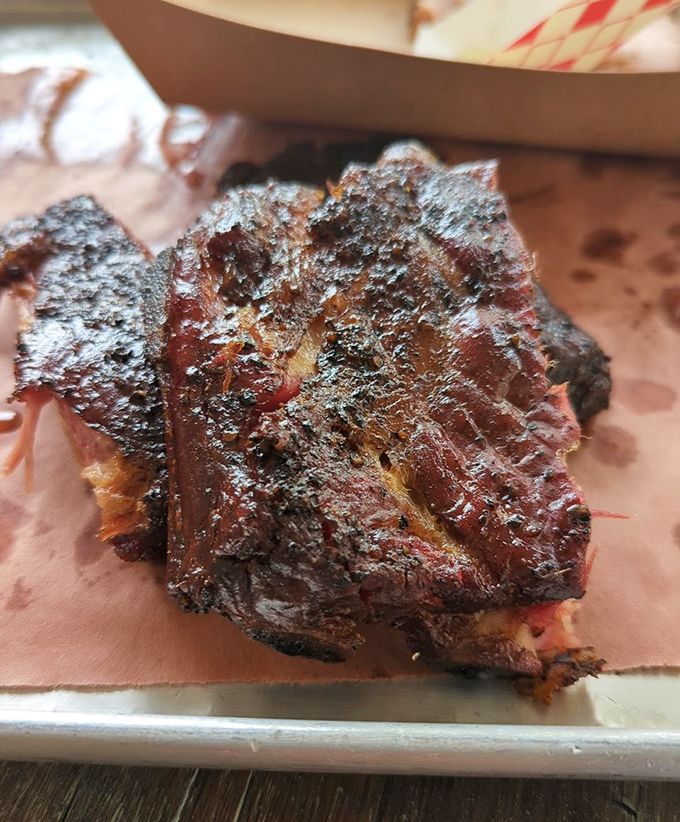 Behold the bark! These ribs wear their smoke ring like a badge of honor. The kind of meat that makes vegetarians question their life choices.