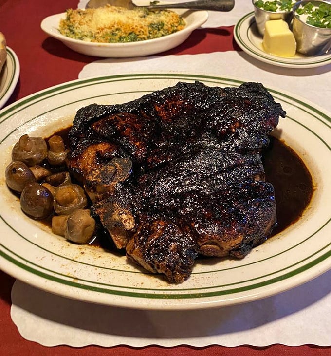Behold the porterhouse in its natural habitat: charred exterior, juicy interior, mushroom companions. This isn't just dinner; it's a religious experience.