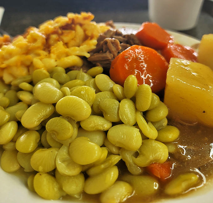 Southern alchemy at its finest: tender pot roast swimming in gravy alongside butter-yellow lima beans and mac and cheese. Grandmothers everywhere are nodding in approval.