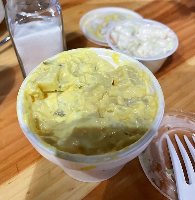 Behold the unsung hero &ndash; creamy, mustard-tinged potato salad that's like a cool oasis in a desert of spice. Your taste buds will thank you for this mercy.