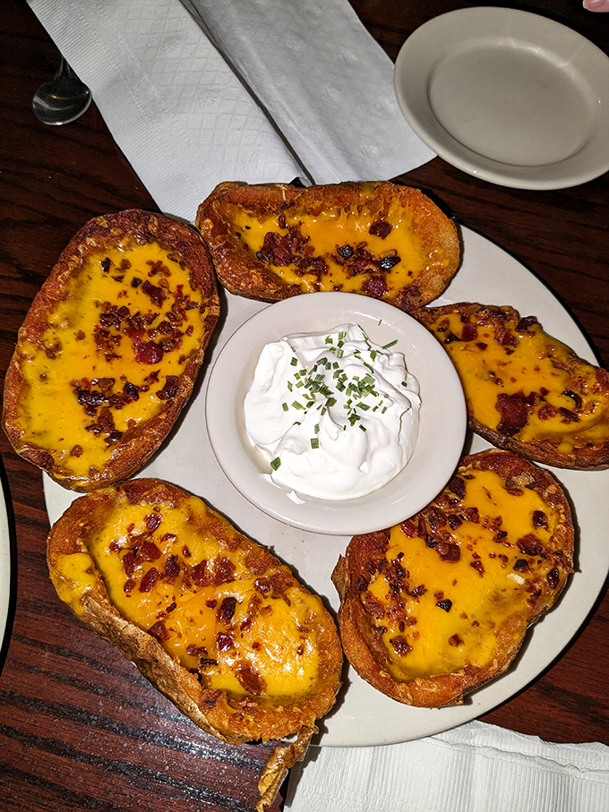 These loaded potato skins aren't just appetizers; they're little boats of joy sailing across a sea of melted cheese and bacon bits toward your happy place.
