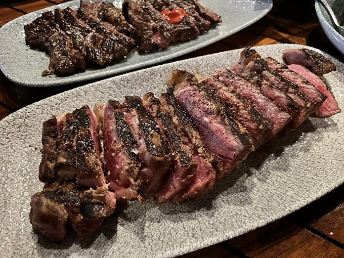 Behold the star of the show&mdash;a perfectly charred New York strip with that quintessential rosy center. This isn't just steak; it's performance art.