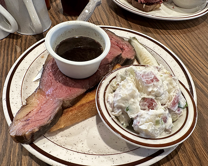 Behold the star of the show: prime rib cooked to that perfect shade of pink, accompanied by au jus that deserves its own fan club.