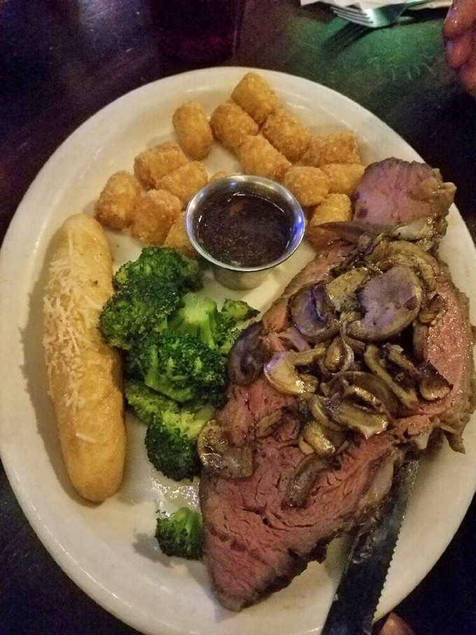 Not just prime rib, but a prime rib epiphany—perfectly pink, mushroom-crowned, and accompanied by tater tots that somehow make the whole experience even more magnificent.