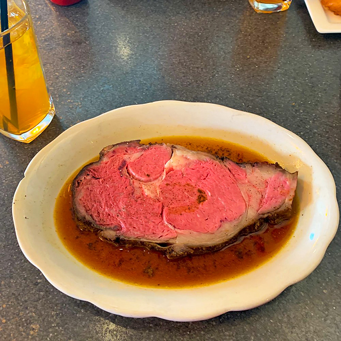 Prime rib perfection &ndash; a rosy center surrounded by a seasoned crust, swimming in au jus that could make a vegetarian question their life choices.