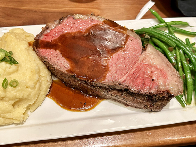 This isn't just prime rib&mdash;it's a masterpiece of meat, perfectly pink and accompanied by creamy mashed potatoes and vibrant green beans.