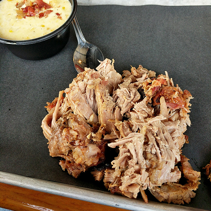 Behold the star attraction: pulled pork with perfect bark-to-meat ratio that makes time stand still with each tender, smoky bite.