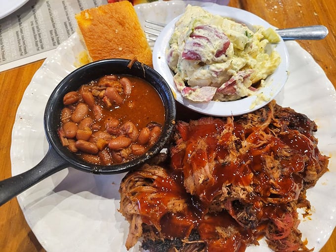 Pulled pork so tender it practically surrenders to your fork. The holy trinity of meat, beans, and potato salad.