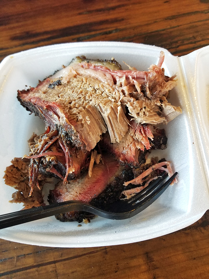 Behold the brisket in all its glory &ndash; that perfect pink smoke ring is like nature's way of saying "you're welcome."