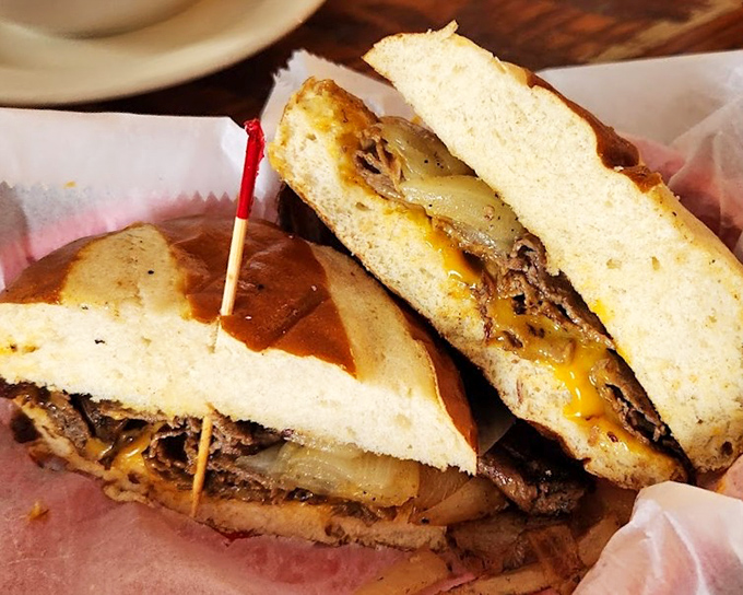 The legendary pulled pork sandwich in all its glory. That melted cheese cascading over tender meat is the kind of sight that makes grown adults weak at the knees. 