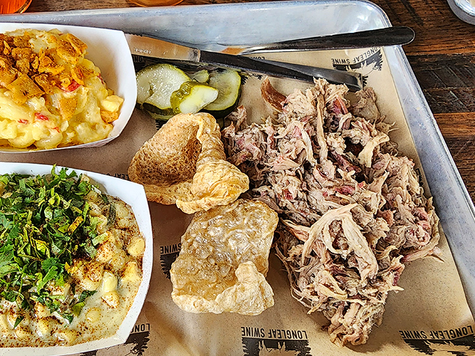 Behold the star of the show: tender pulled pork with perfect bark distribution, accompanied by sides that refuse to be mere afterthoughts.