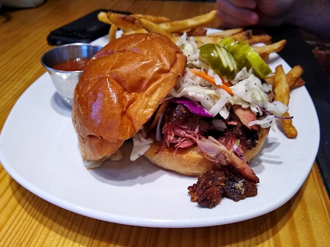 This pulled pork sandwich isn't just a meal, it's a life event. Tender meat, crunchy slaw, and a brioche bun that deserves its own fan club.