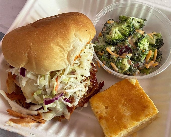 The star of the show: Hood's pulled pork sandwich with coleslaw that doesn't know the meaning of "subtle." That cornbread square isn't a side&mdash;it's an essential supporting character.
