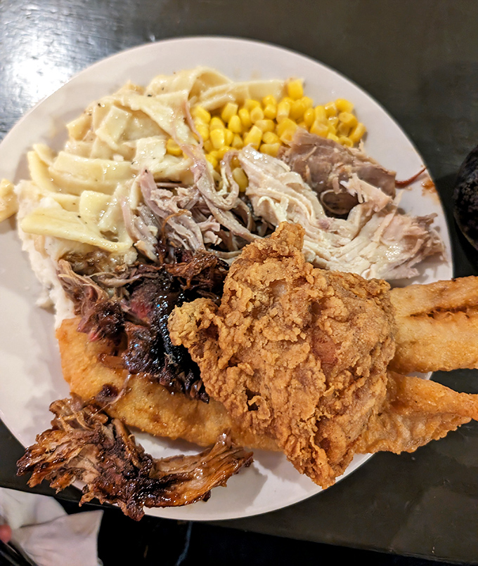 The ultimate sampler plate&mdash;tender pulled pork, crispy fried chicken, and homestyle sides that make decision-making the hardest part of your meal.