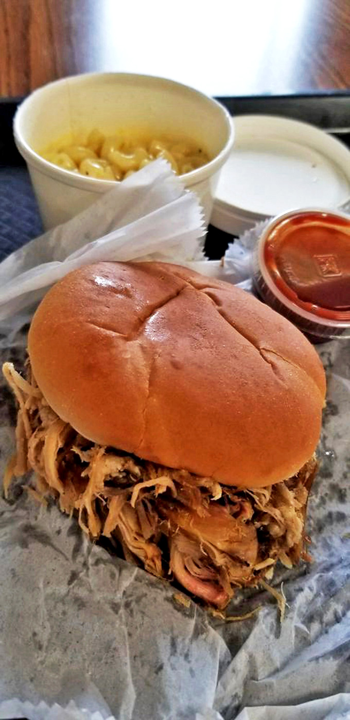 This pulled pork sandwich isn't just a meal; it's a masterclass in meat-to-bun ratio that would make architecture students take notes.