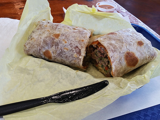 This burrito isn't just a meal; it's an architectural marvel of perfectly distributed ingredients wrapped in a tortilla that's achieved golden-brown perfection.