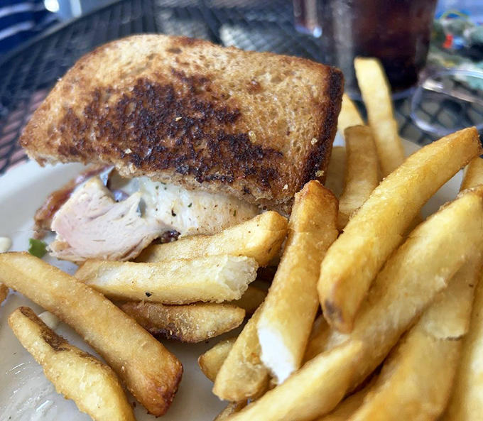 This sandwich isn't just lunch&mdash;it's therapy between bread. Golden fries standing at attention like they know they're part of something special.