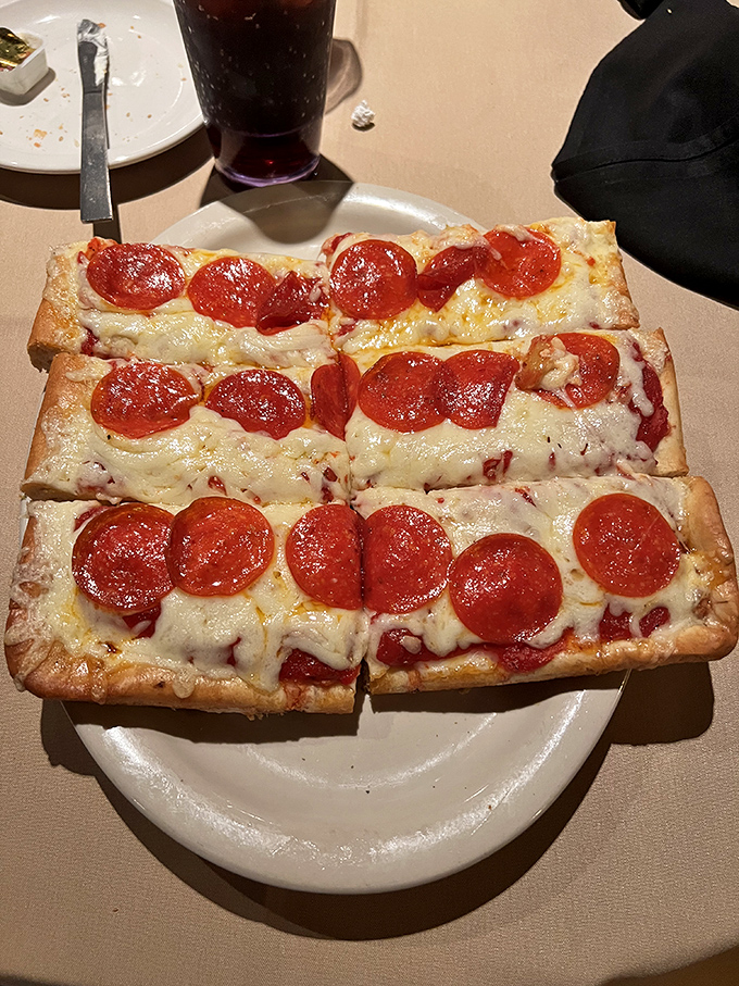 Old Forge pizza isn't just rectangular&mdash;it's a geometry lesson in perfect proportions: thick-yet-light crust supporting that distinctive cheese blend and pepperoni that curls into flavor cups.