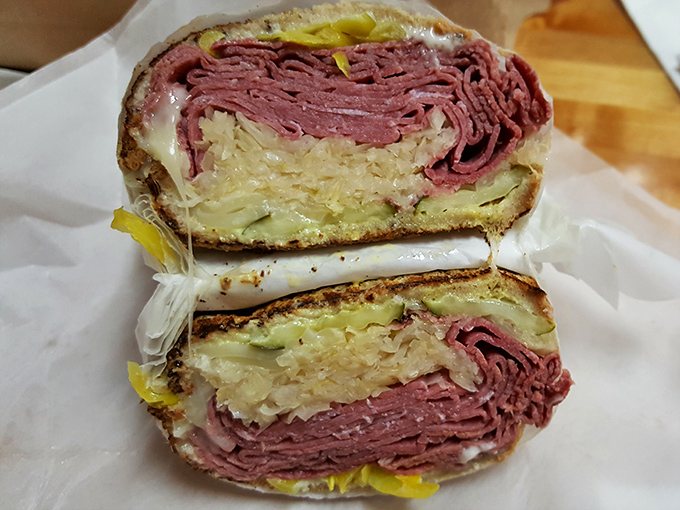 Behold the star attraction: layers of corned beef, sauerkraut, and Swiss cheese melting together in Reuben sandwich perfection.