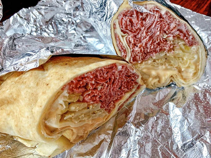 Behold the star of our show! This Reuben wrap reveals its secrets: perfectly pink corned beef, tangy sauerkraut, and melty Swiss cheese in perfect harmony.