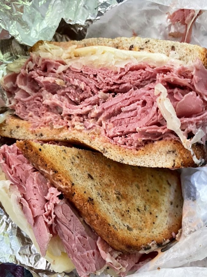 Behold the architectural marvel that is Attman's corned beef sandwich. Meat stacked higher than your expectations, with each pink layer promising perfection.