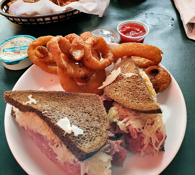 This Reuben isn't just a sandwich; it's an engineering marvel of corned beef, sauerkraut, and melted Swiss. Those onion rings aren't playing supporting roles&mdash;they're scene-stealers.