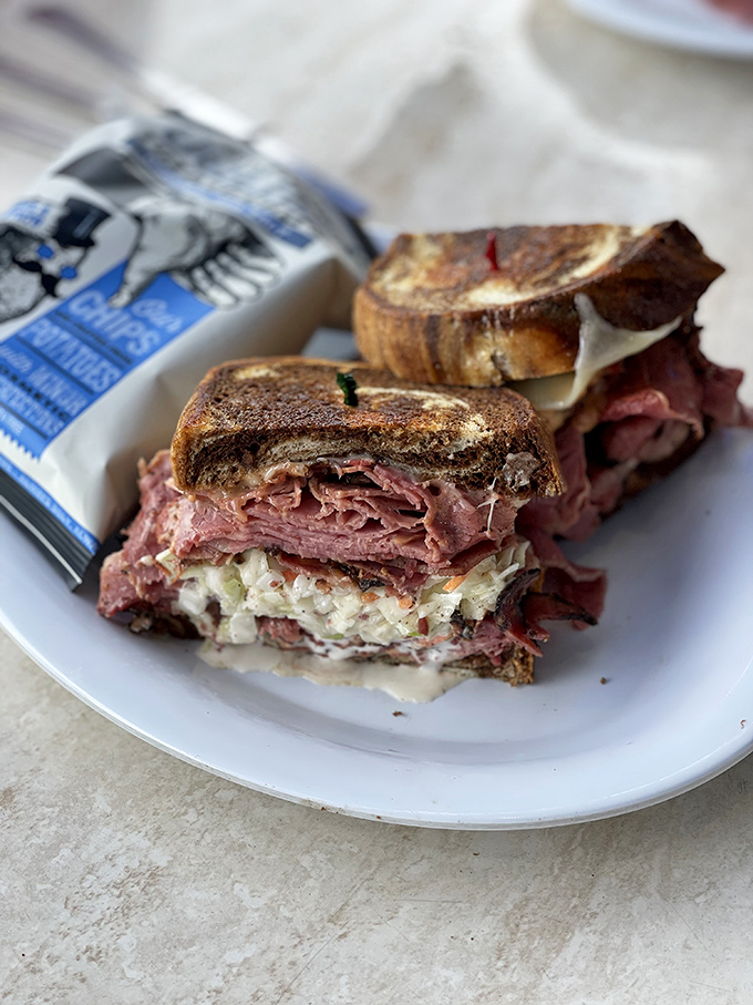 Behold the Reuben in its natural habitat &ndash; perfectly grilled rye, corned beef stacked with intention, and sauerkraut that means business.