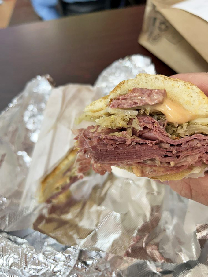 Behold the star of our show: layers of corned beef stacked with mathematical precision between rye bread that's achieved golden-brown perfection.