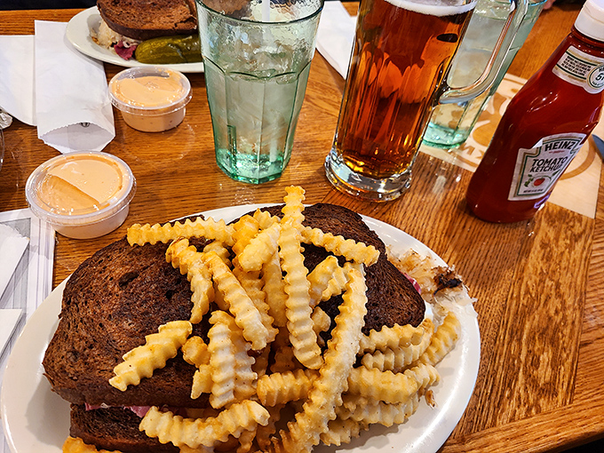 This isn't just a sandwich; it's architecture with flavor. The crispy crinkle-cut fries stand at attention, ready for their supporting role.