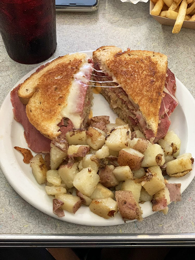 This isn't just a sandwich; it's a masterclass in balance—crispy bread, melty cheese, and home fries that deserve their own fan club.