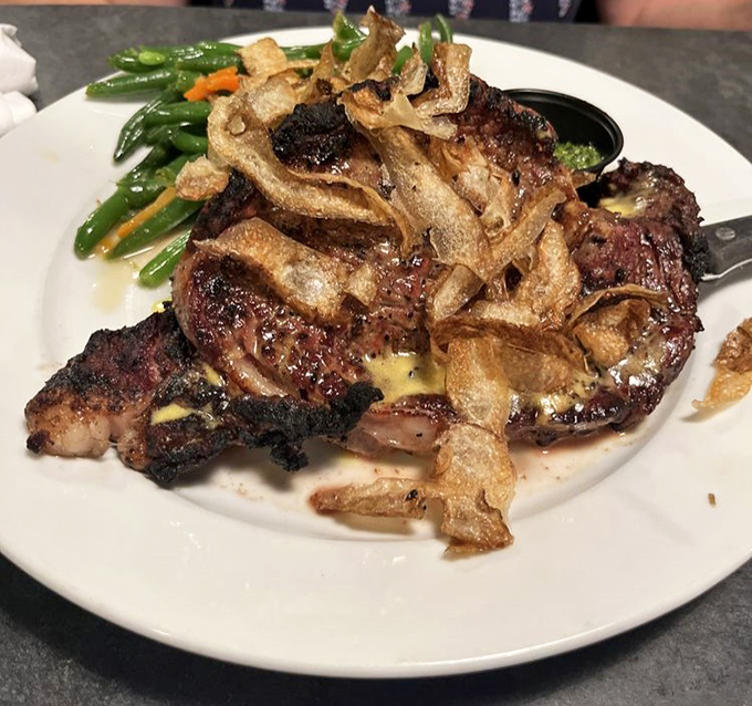 This isn't just a steak&mdash;it's a religious experience with crispy onion straws. The kind that makes you close your eyes and forget table manners exist.
