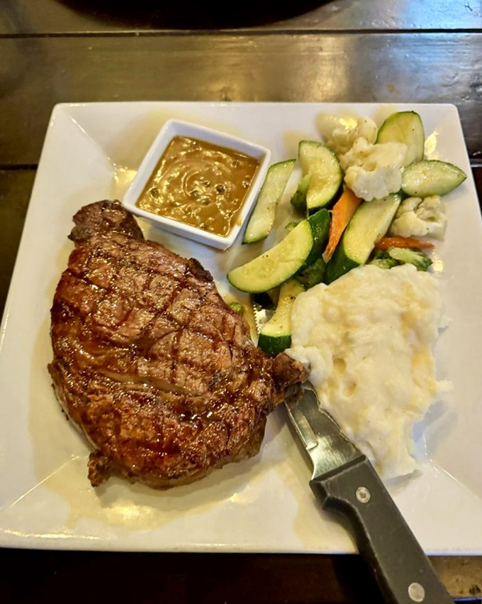 The star of the show: a perfectly charred ribeye steak alongside fresh vegetables and creamy mashed potatoes. Meat candy for grown-ups!