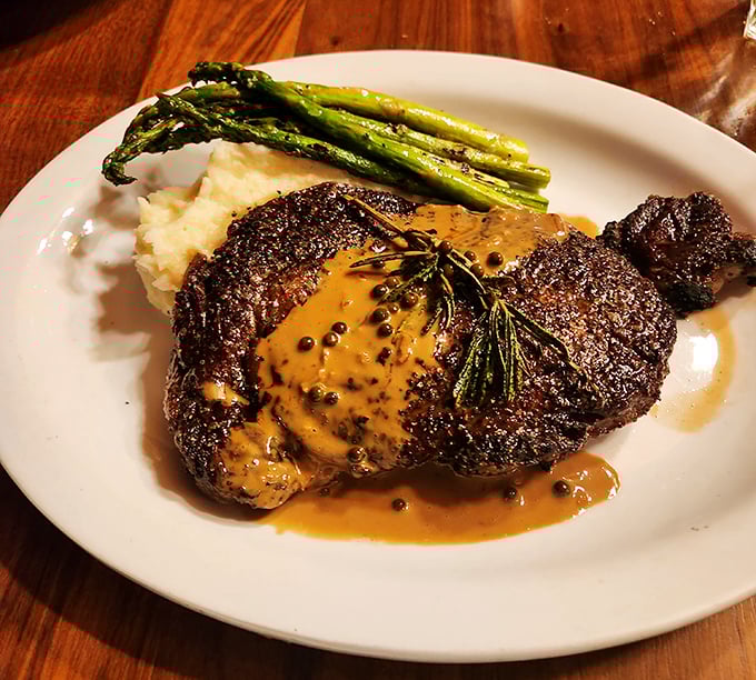 Behold the star of the show! This perfectly seared ribeye with mashed potatoes and asparagus isn't just dinner &ndash; it's a religious experience with gravy.