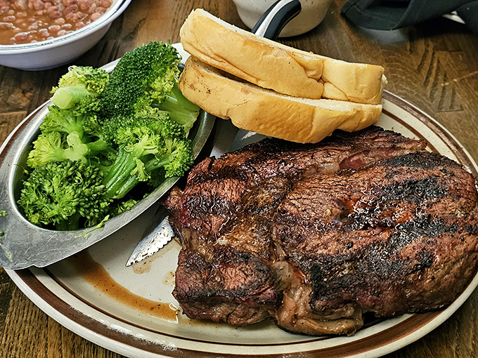 This isn't just a steak—it's a manifesto of meat, with a char that whispers sweet nothings of red oak smoke while that broccoli pretends it's the star.