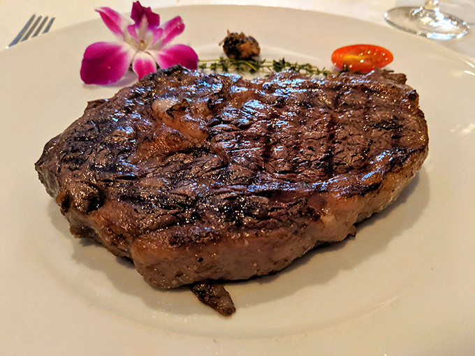 Behold the star of the show: a perfectly seared ribeye with grill marks that should be framed in a museum. That crust is the stuff dreams are made of.