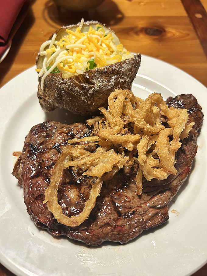 This isn't just a ribeye&mdash;it's a masterpiece topped with crispy onion strings that adds textural contrast to each bite. The loaded baked potato stands ready as the perfect supporting actor.