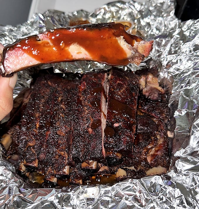 These ribs don't just fall off the bone&mdash;they practically leap into your mouth with that perfect bark, smoke ring, and glossy sauce.